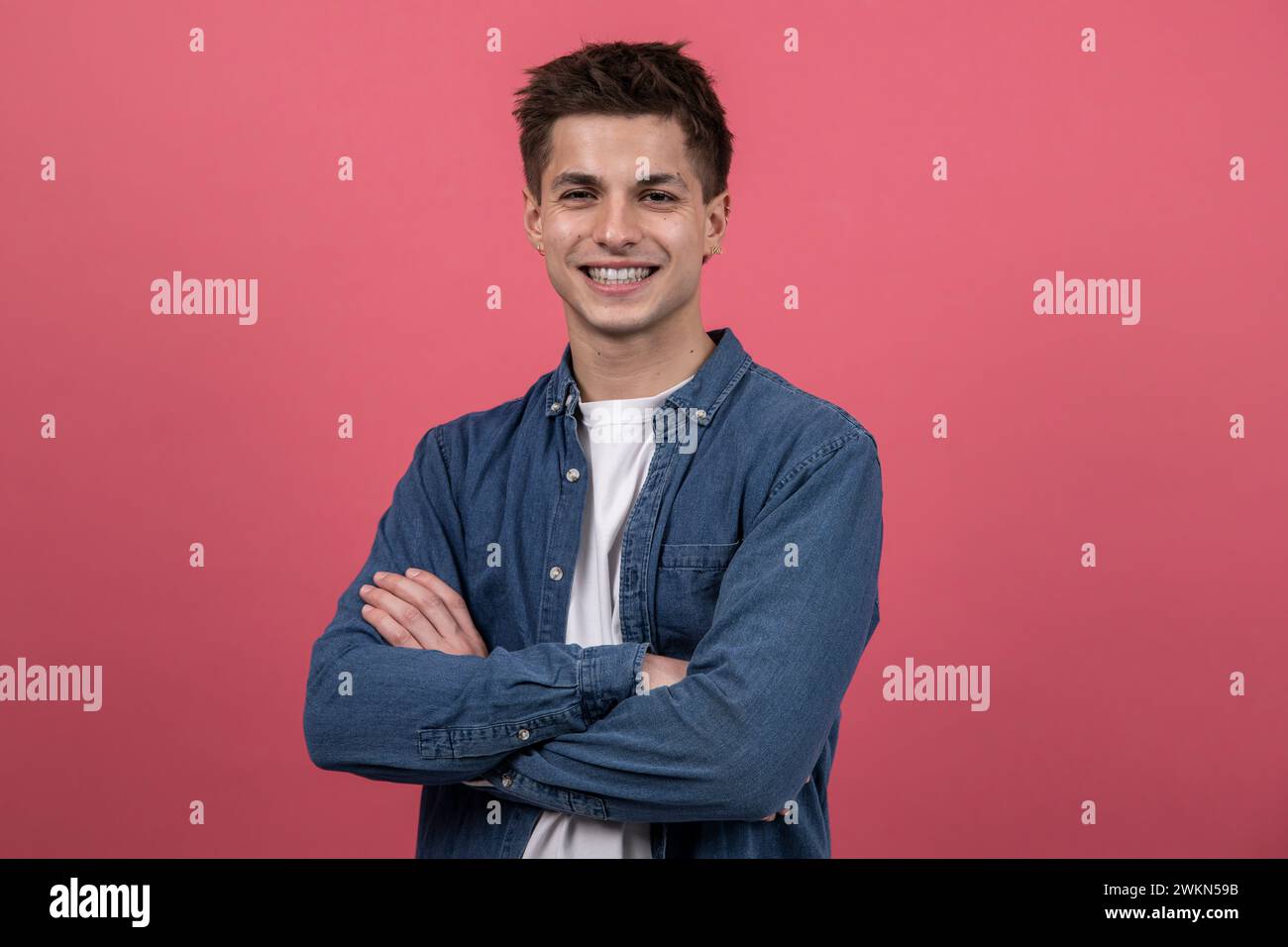 Happy confident laughing guy posing with arms folded. Young relaxed ...