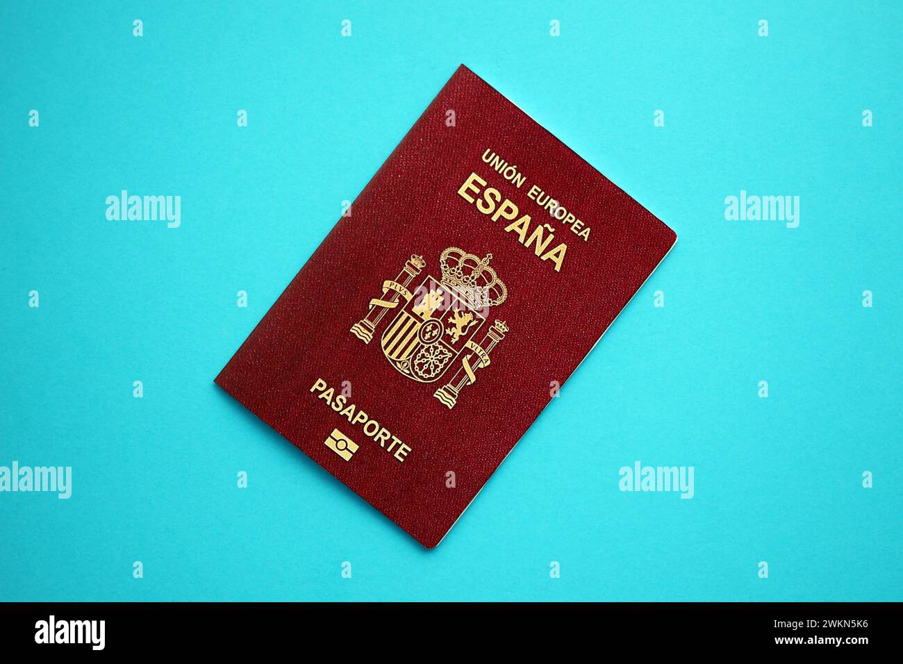 Red Spanish passport of European Union on blue background close up ...