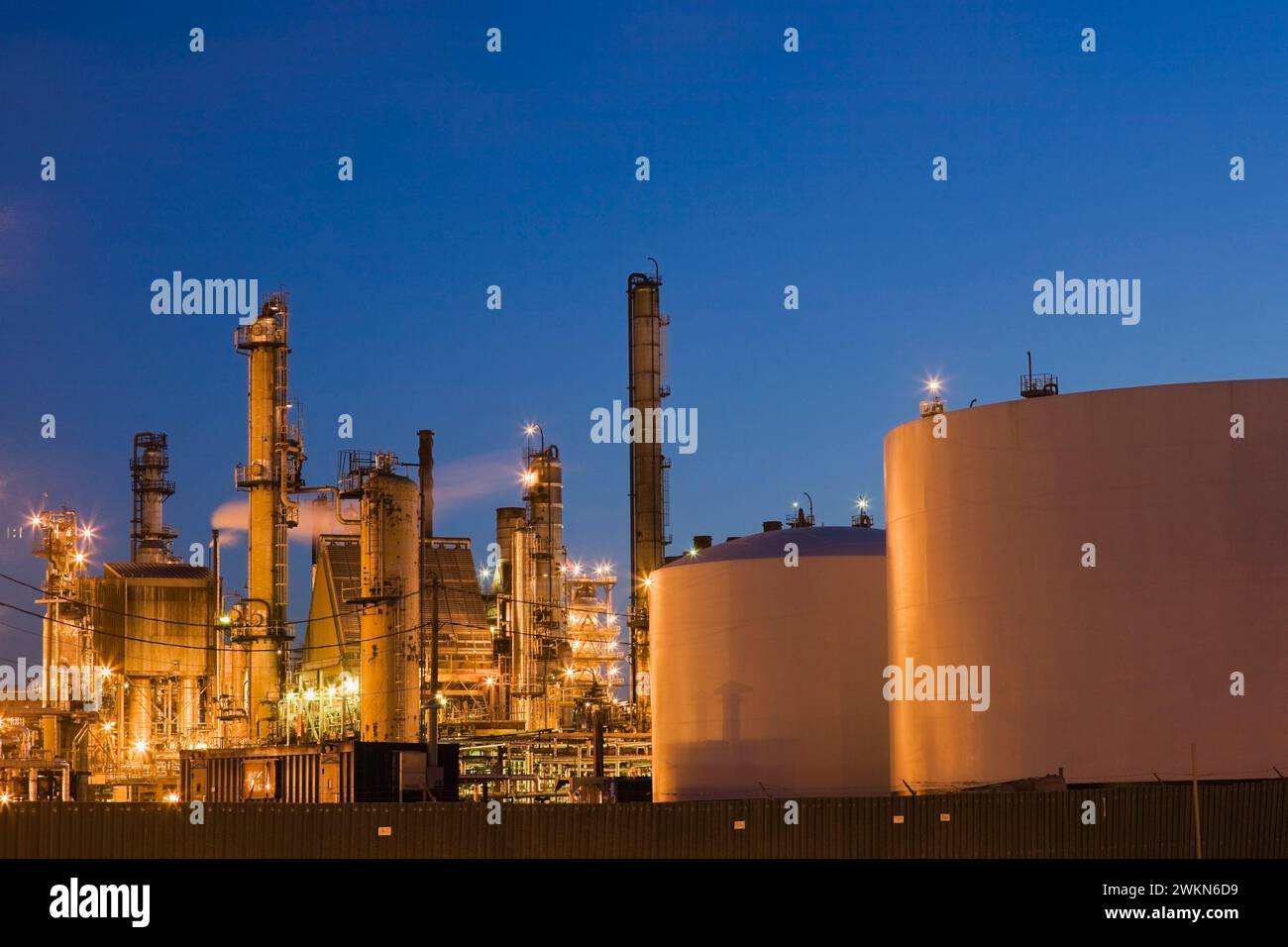 Smokestacks and oil storage tanks at an oil and gas refinery ...