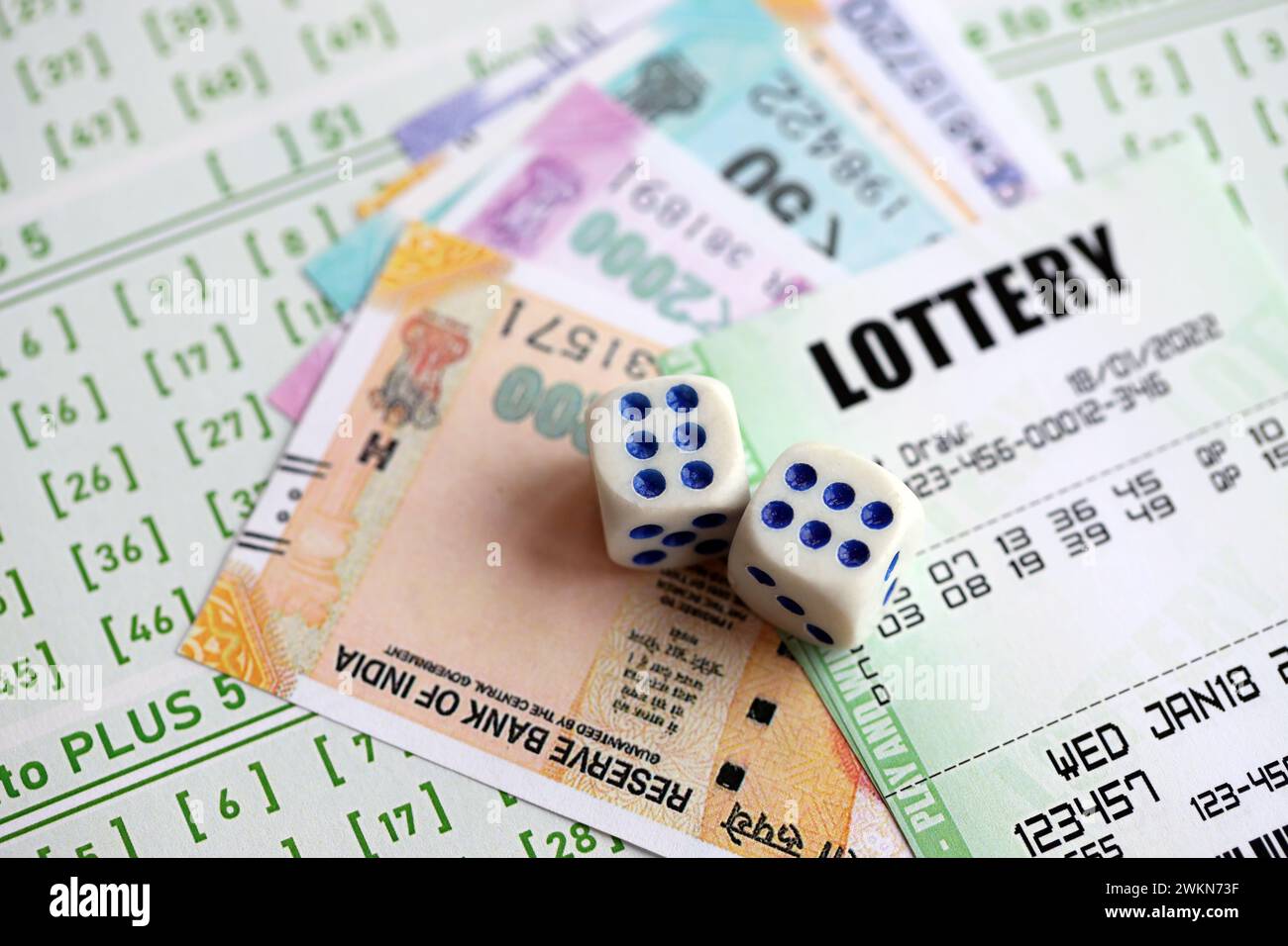 Green lottery tickets and indian rupees money bills on blank with ...