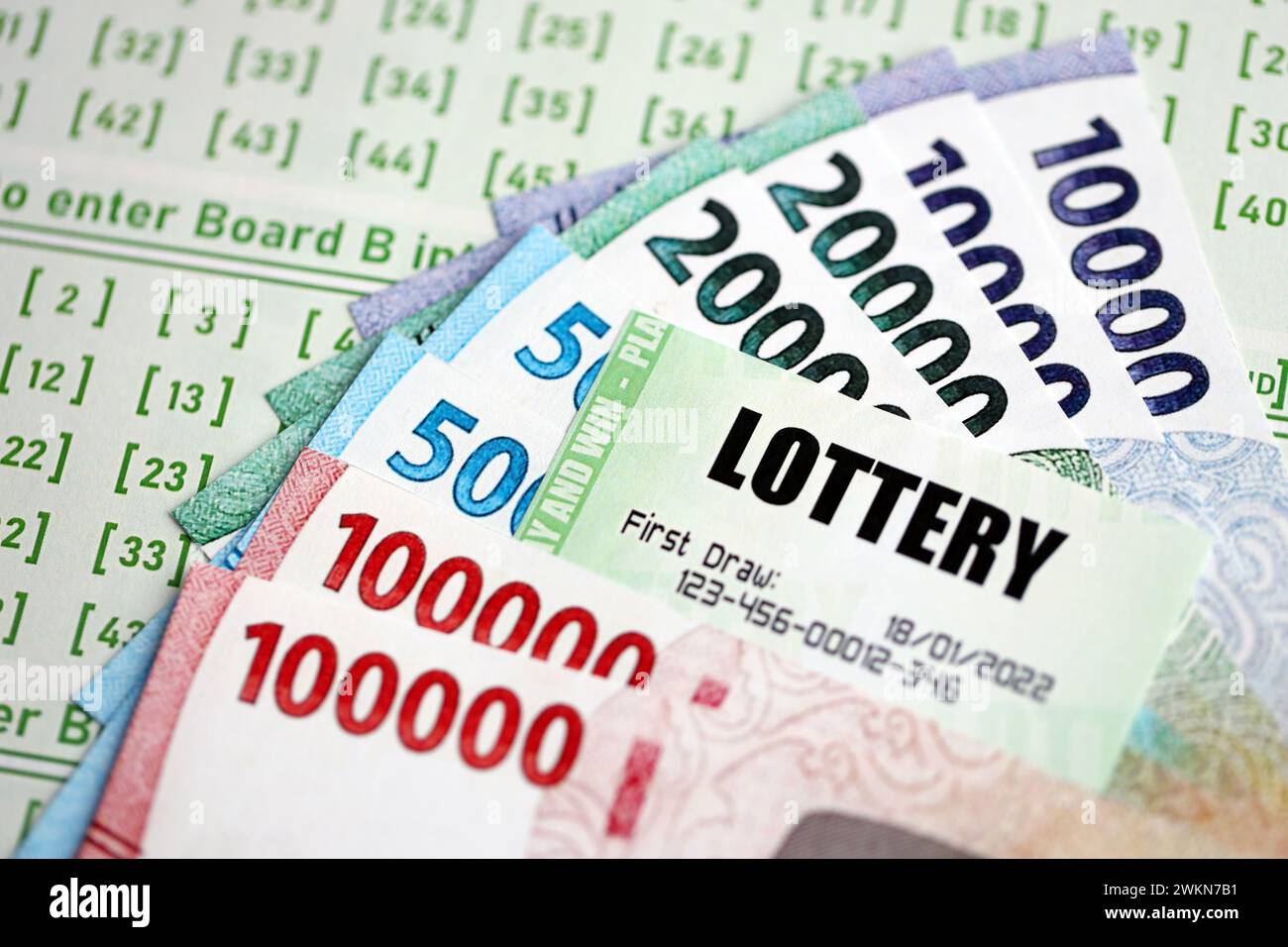 Green lottery tickets and indonesian money bills on blank with numbers ...