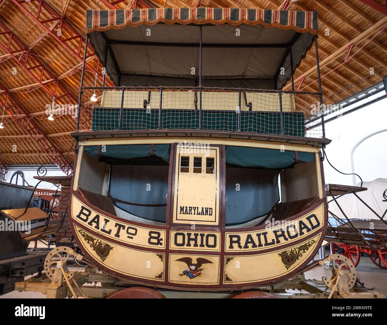 Early passenger railroad car that looked like a stagecoach with upper ...