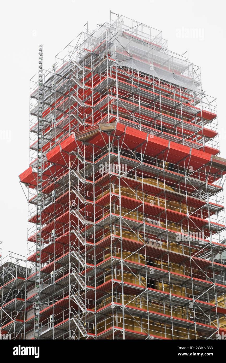 Building exterior with scaffolding undergoing construction and ...
