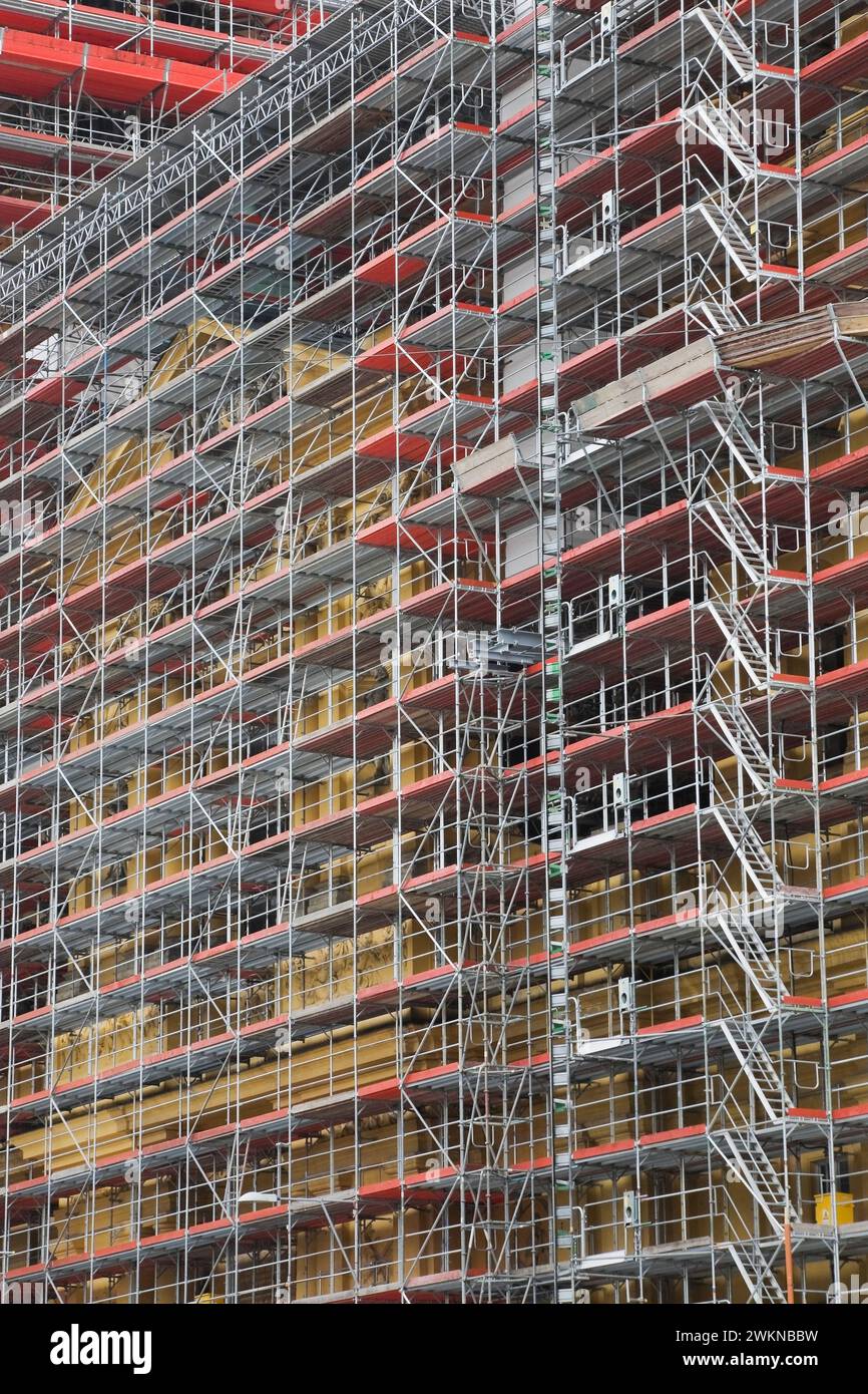 Building exterior with steel scaffolding undergoing construction and ...