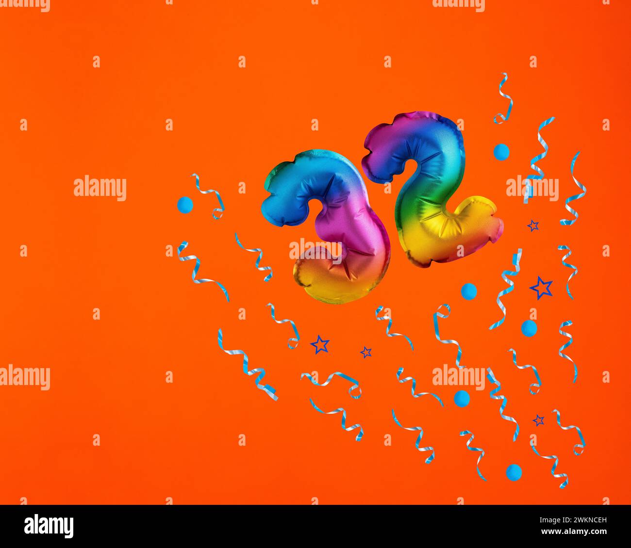 Multicolor balloon number 32 - Confetti explosion on orange background ...