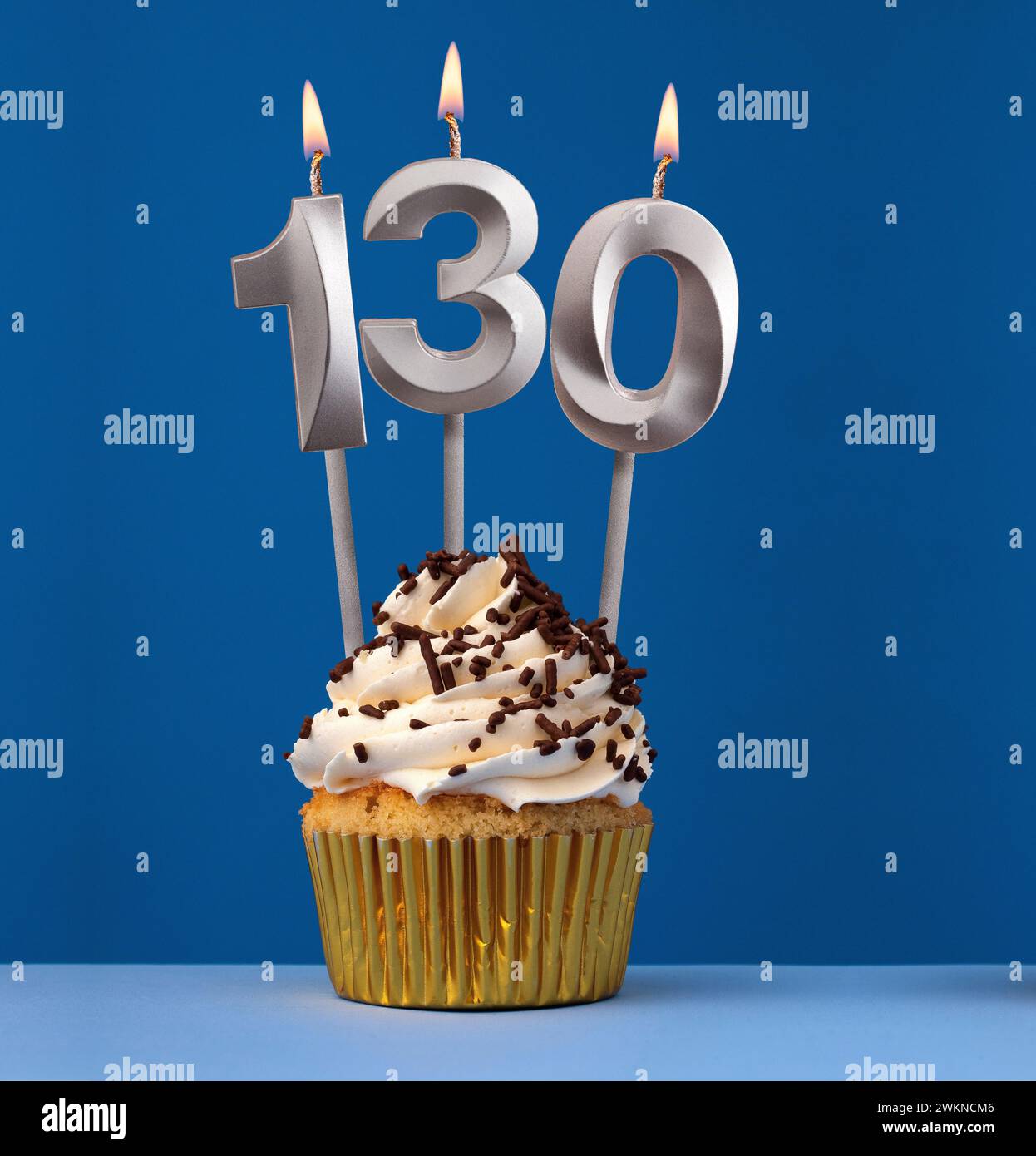 Vertical birthday card with cupcake - Lit candle number 130 on blue ...