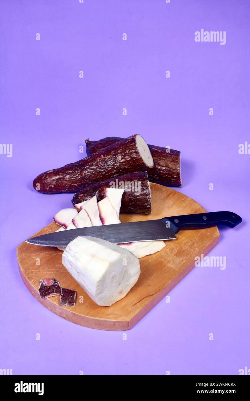 Fresh Organic Cassava Root, Manioc Esculenta, yuca On purple Background ...