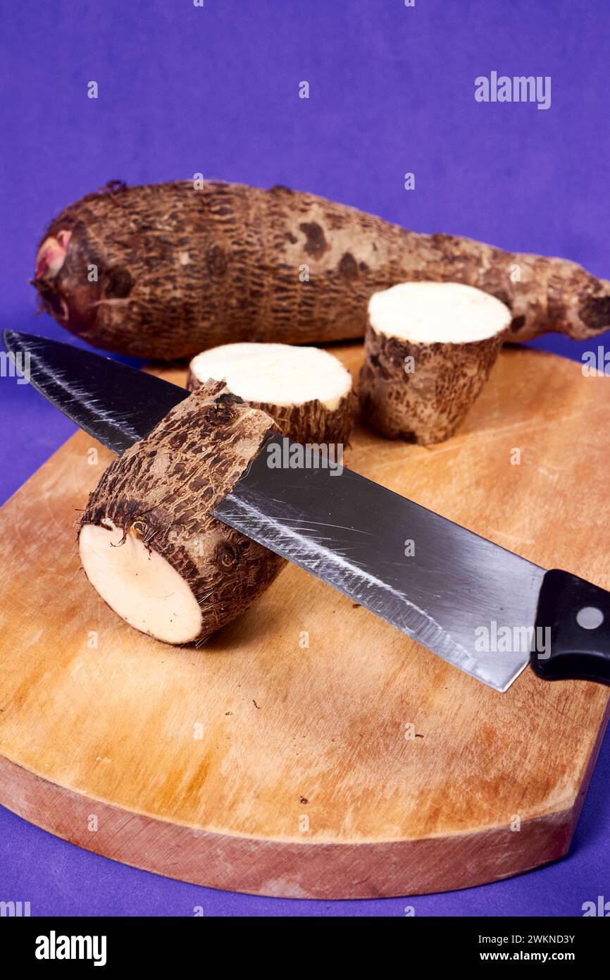 closeup of taro root vegetable, eddo malanga, hands table slice Stock ...