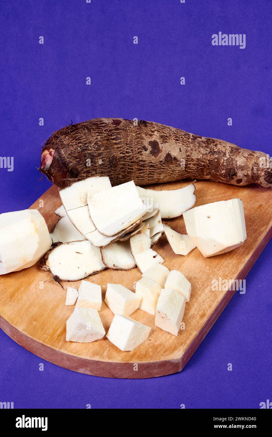 closeup of taro root vegetable, eddo malanga, hands table slice Stock ...