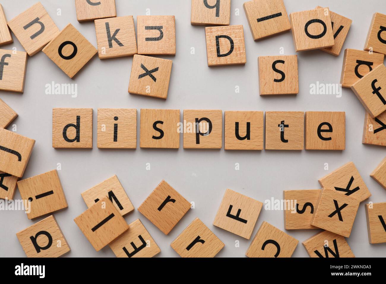 Squares with word Dispute on light grey background, flat lay Stock ...