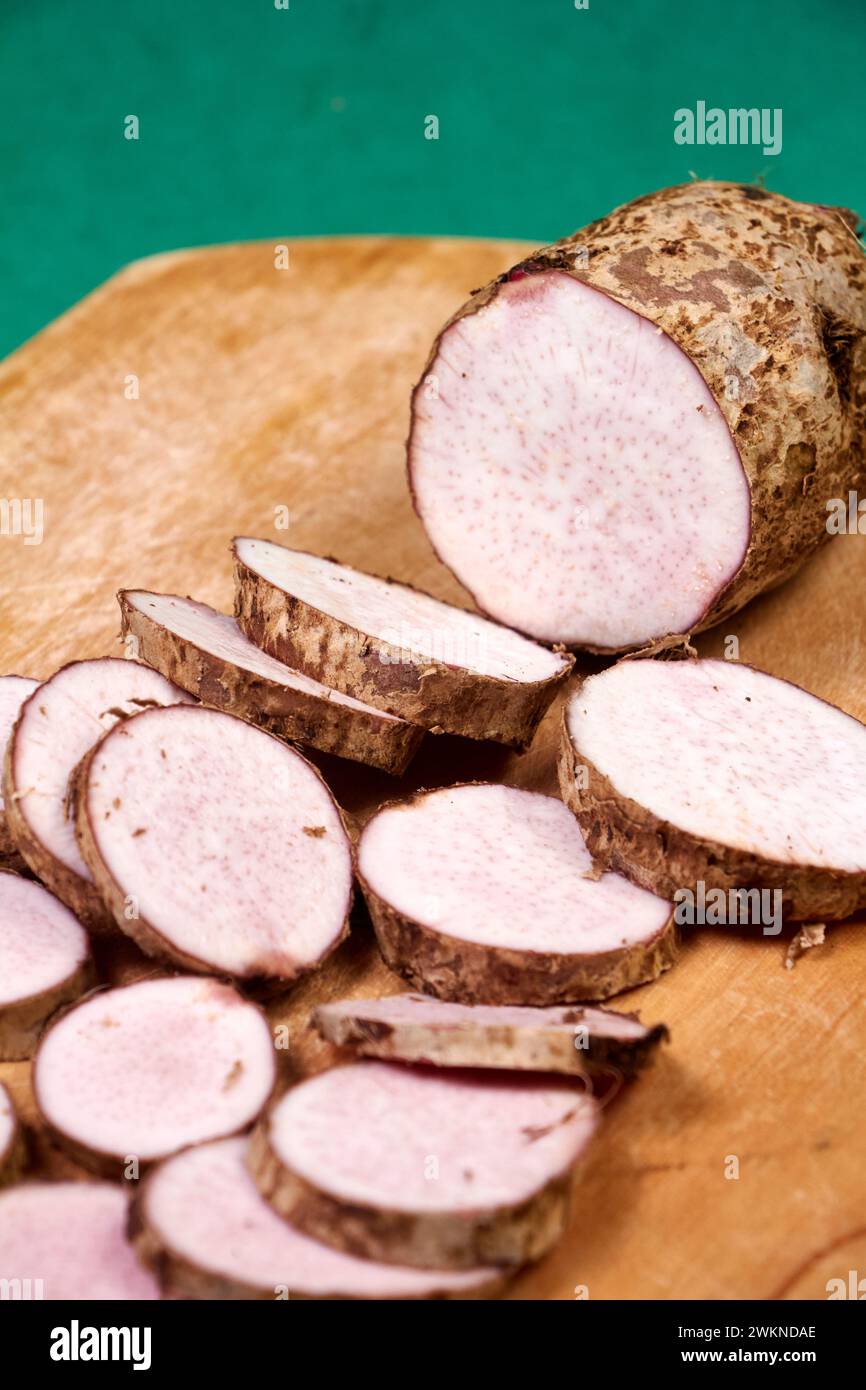 closeup of taro root vegetable, eddo malanga, hands table slice Stock ...