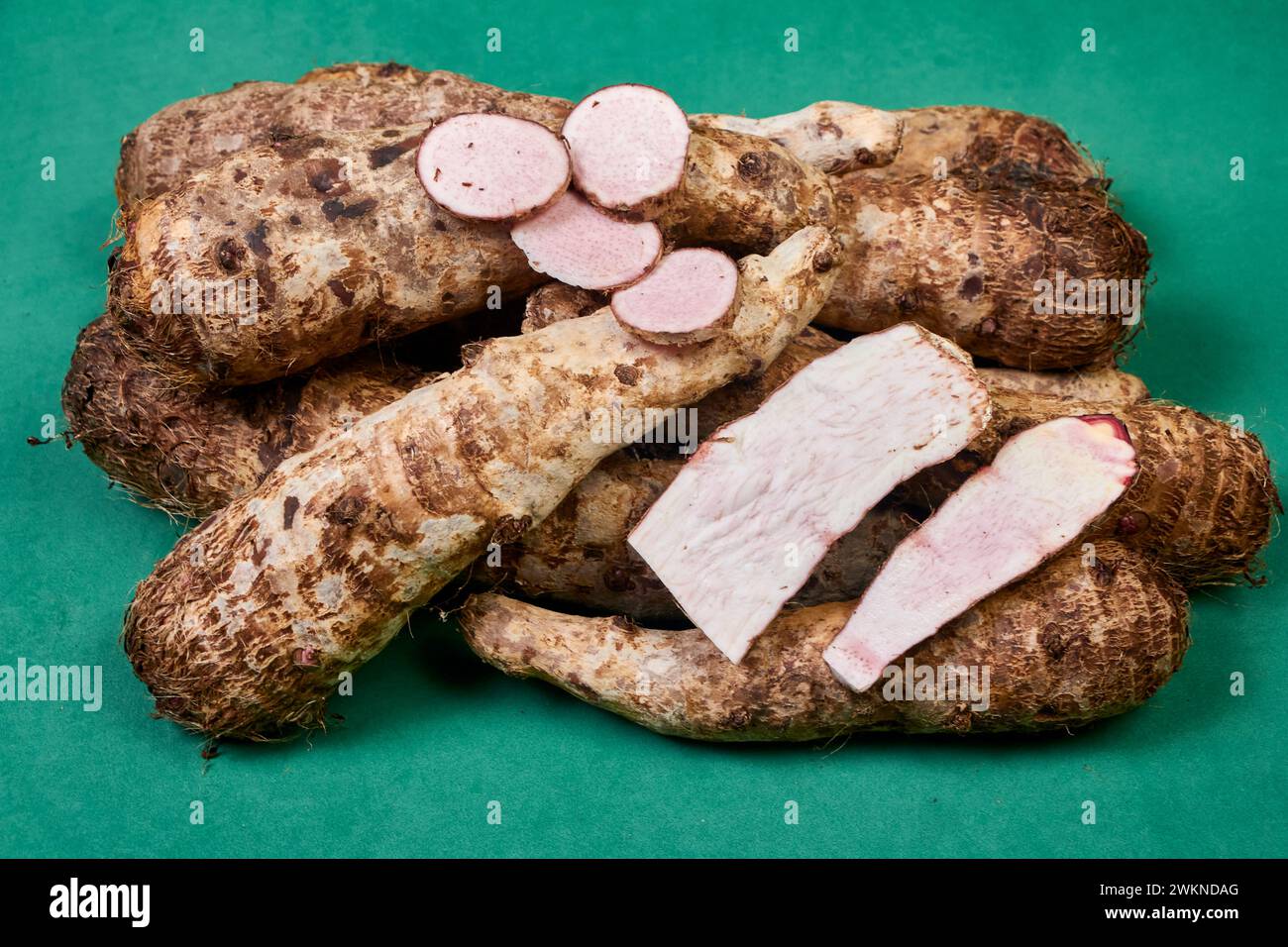 closeup of taro root vegetable, eddo malanga, hands table slice Stock ...
