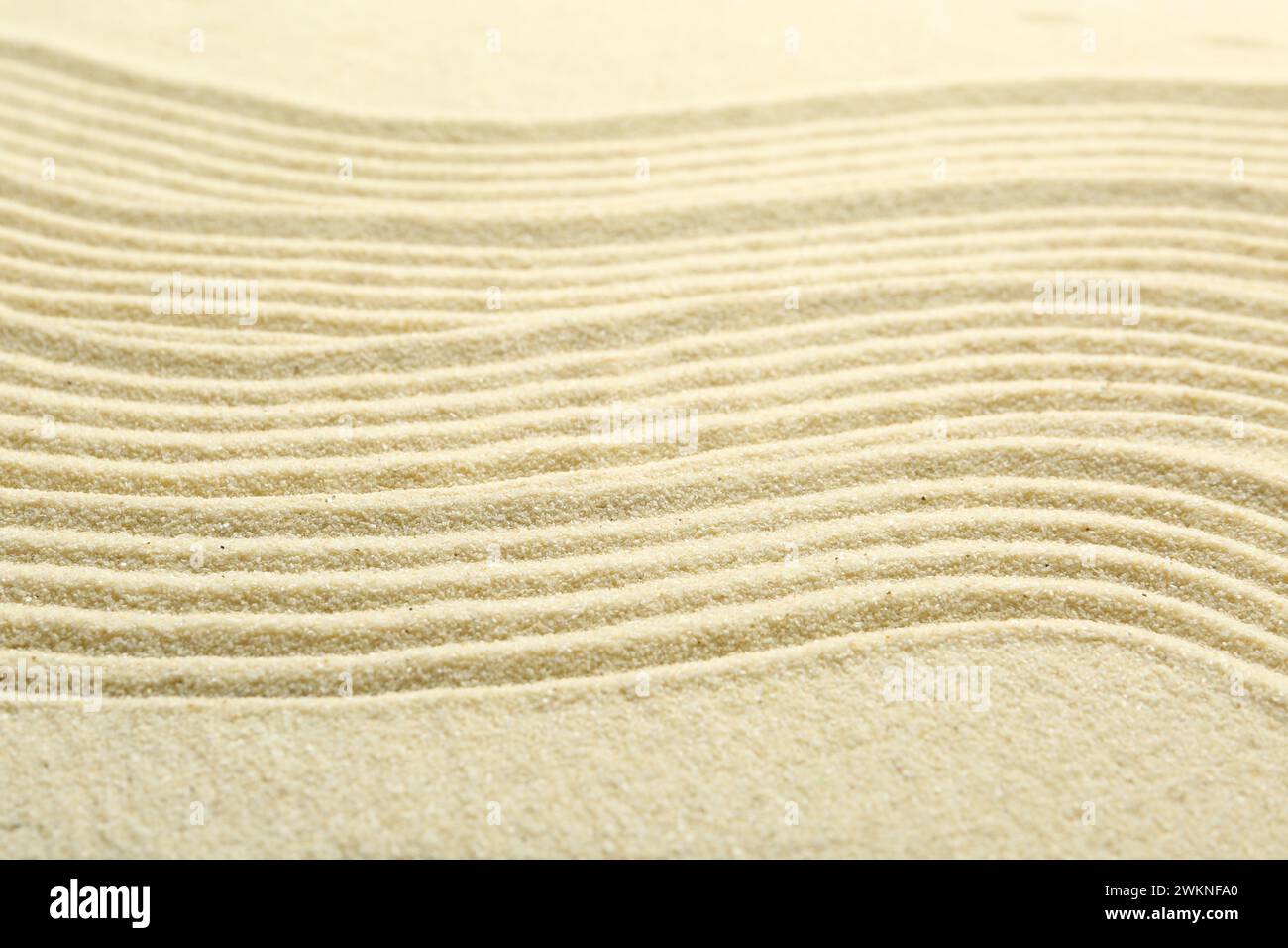 Zen rock garden. Wave pattern on beige sand Stock Photo - Alamy