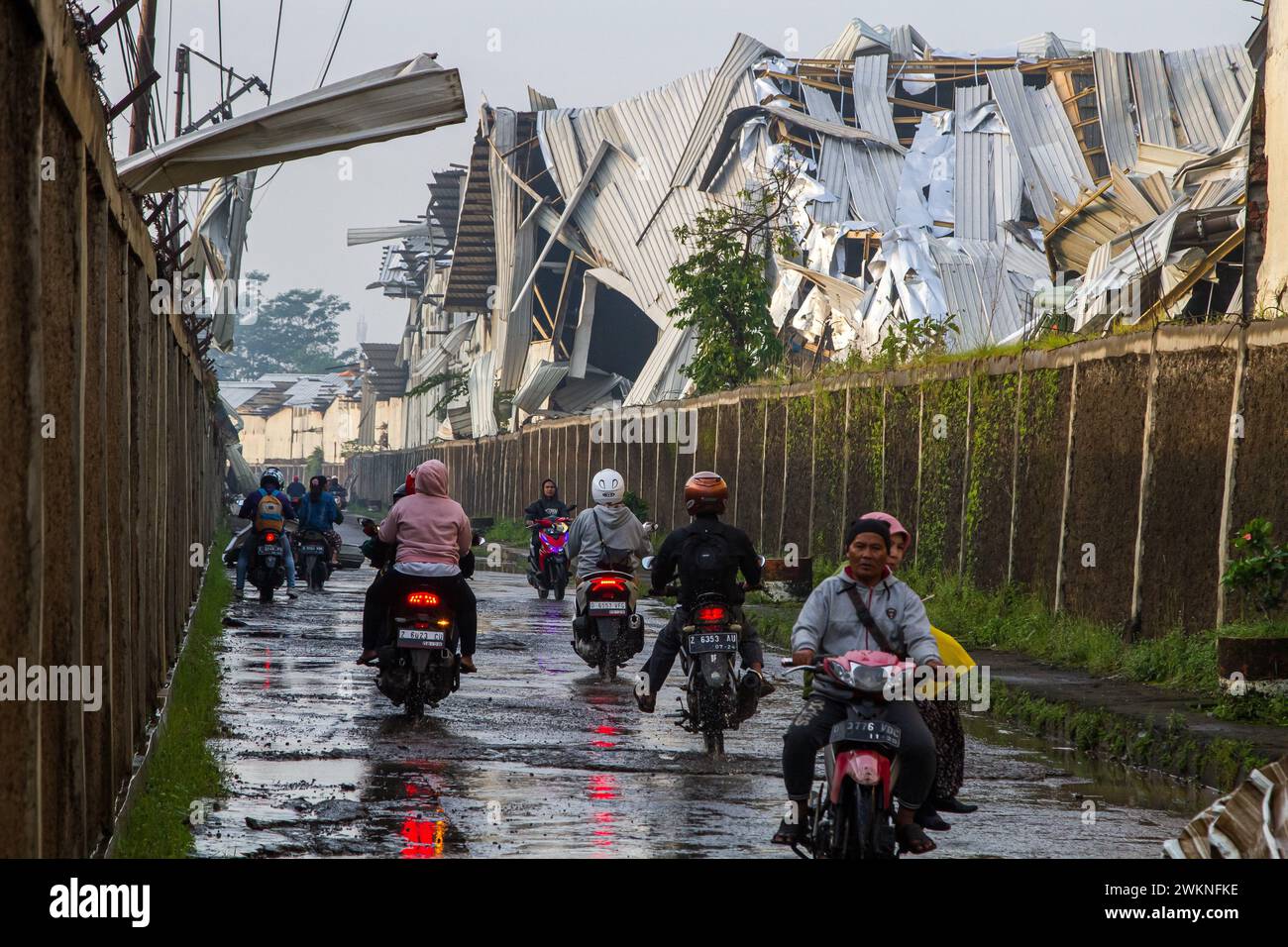 Sumedang Regency, West Java, Indonesia. 22nd Feb, 2024. Motorcyclists pass a factory building ...