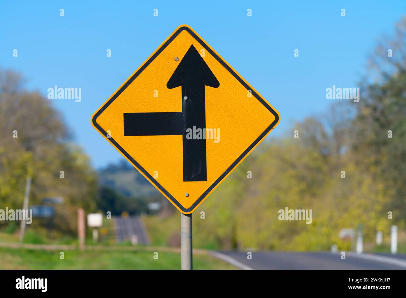 Intersection road sign showing black arrow for direction symbol with a ...