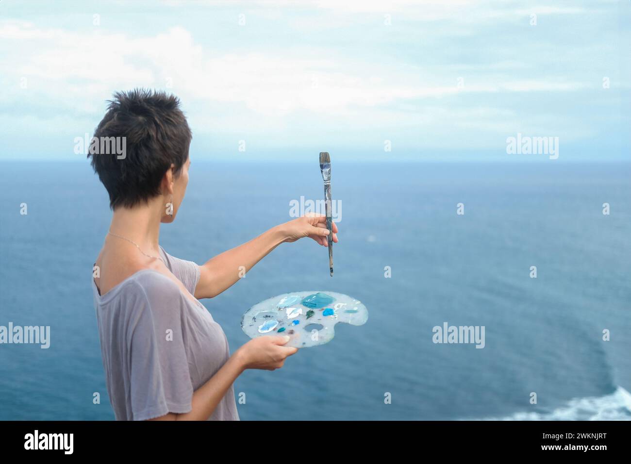 Portrait of an artist against the backdrop of the ocean. Paints a ...