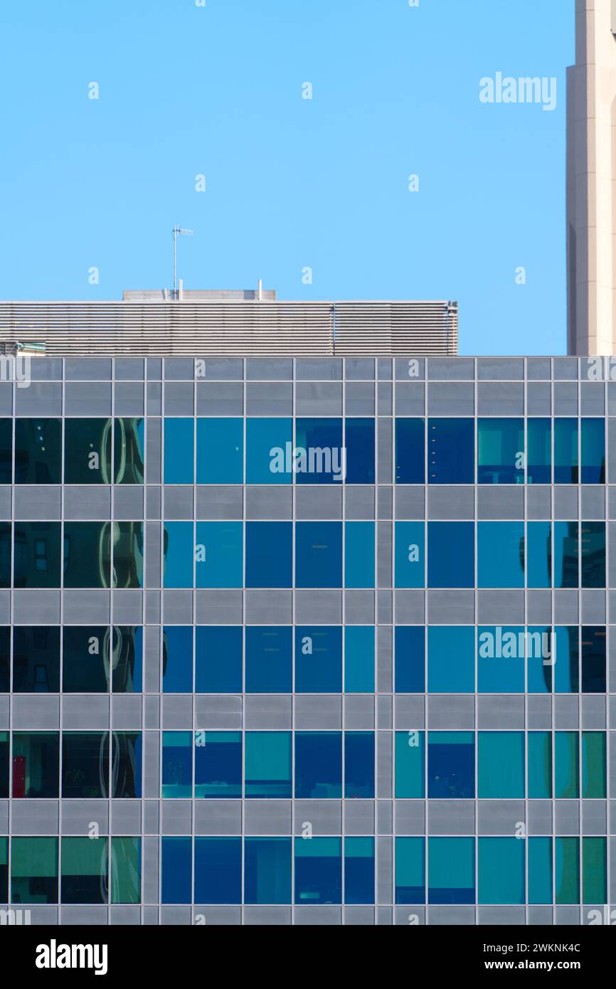 Abstract office building day time view showing blue glass window ...