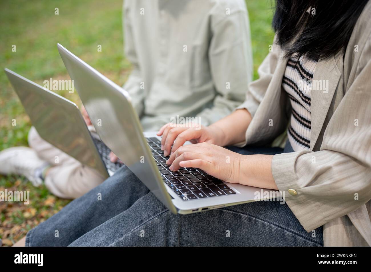 A close-up shot of two college students collaborating on work and using ...