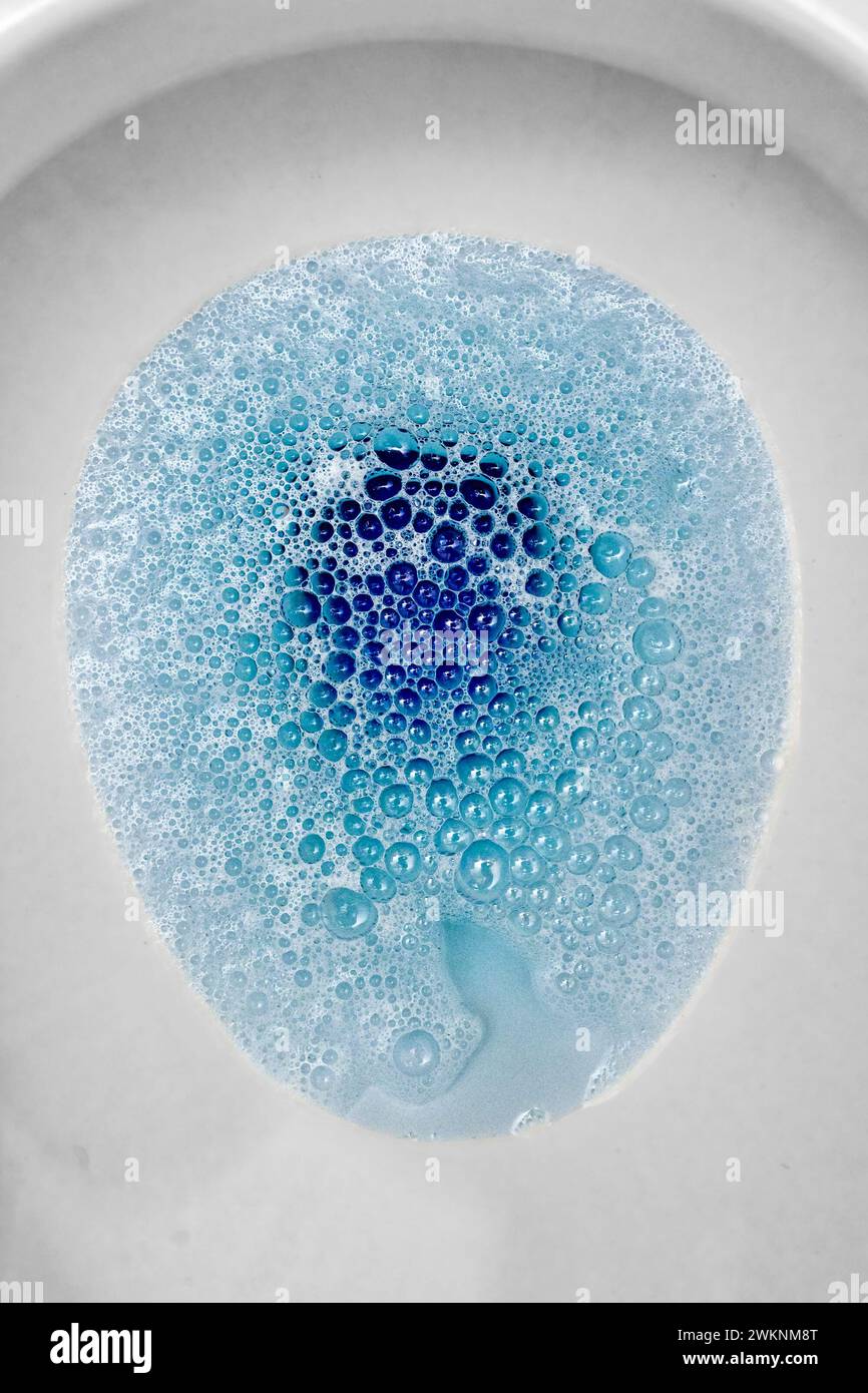 Blue toilet bowl cleaner bubbles in toilet Stock Photo - Alamy