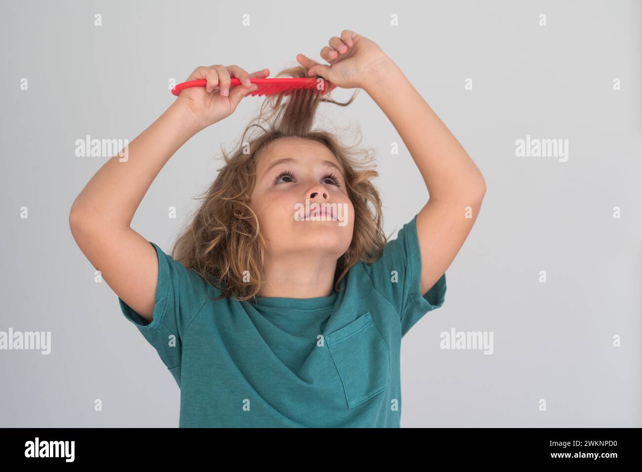 Boy brushes his hair. Little child boy combing hair, isolated ...