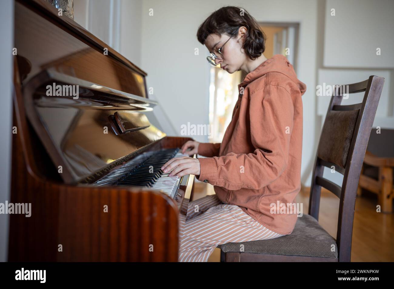 Concentrated on playing classical music on piano, pianist girl touch ...