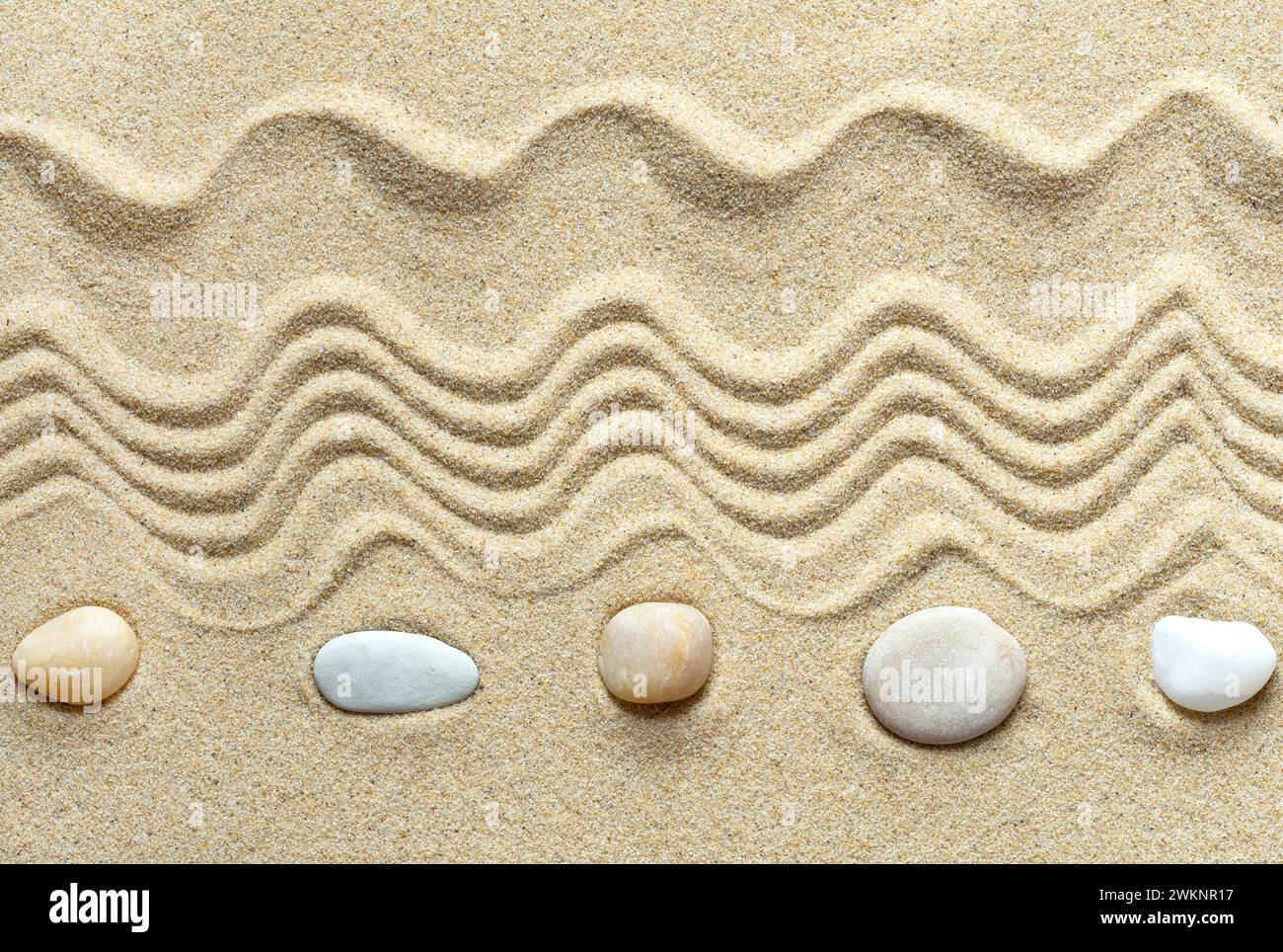 Zen garden with the sand pattern and stones Stock Photo - Alamy