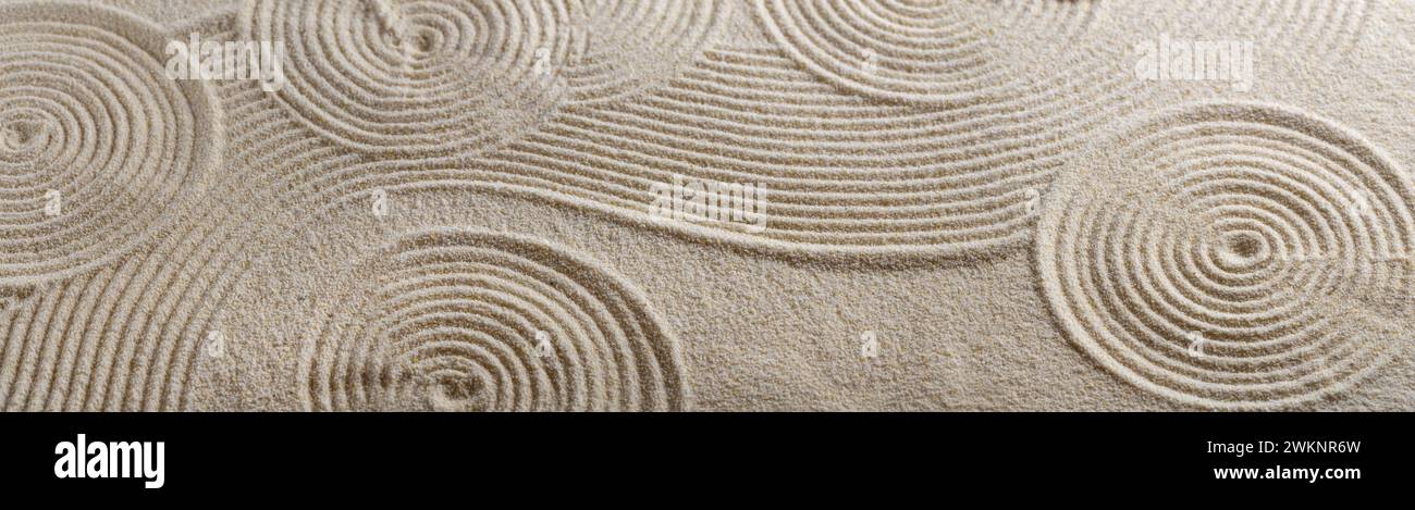 Zen garden with the sand pattern and stones Stock Photo - Alamy