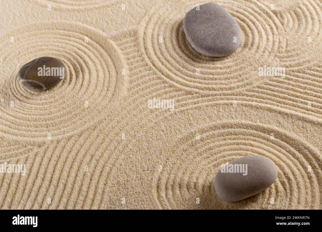 Zen garden with the sand pattern and stones Stock Photo - Alamy