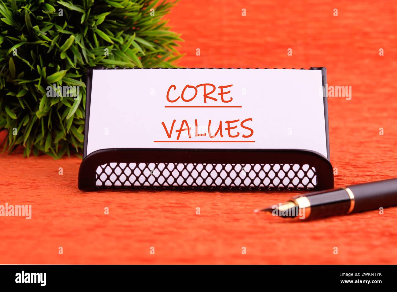 CORE VALUES word written on a white card on a stand on an orange ...