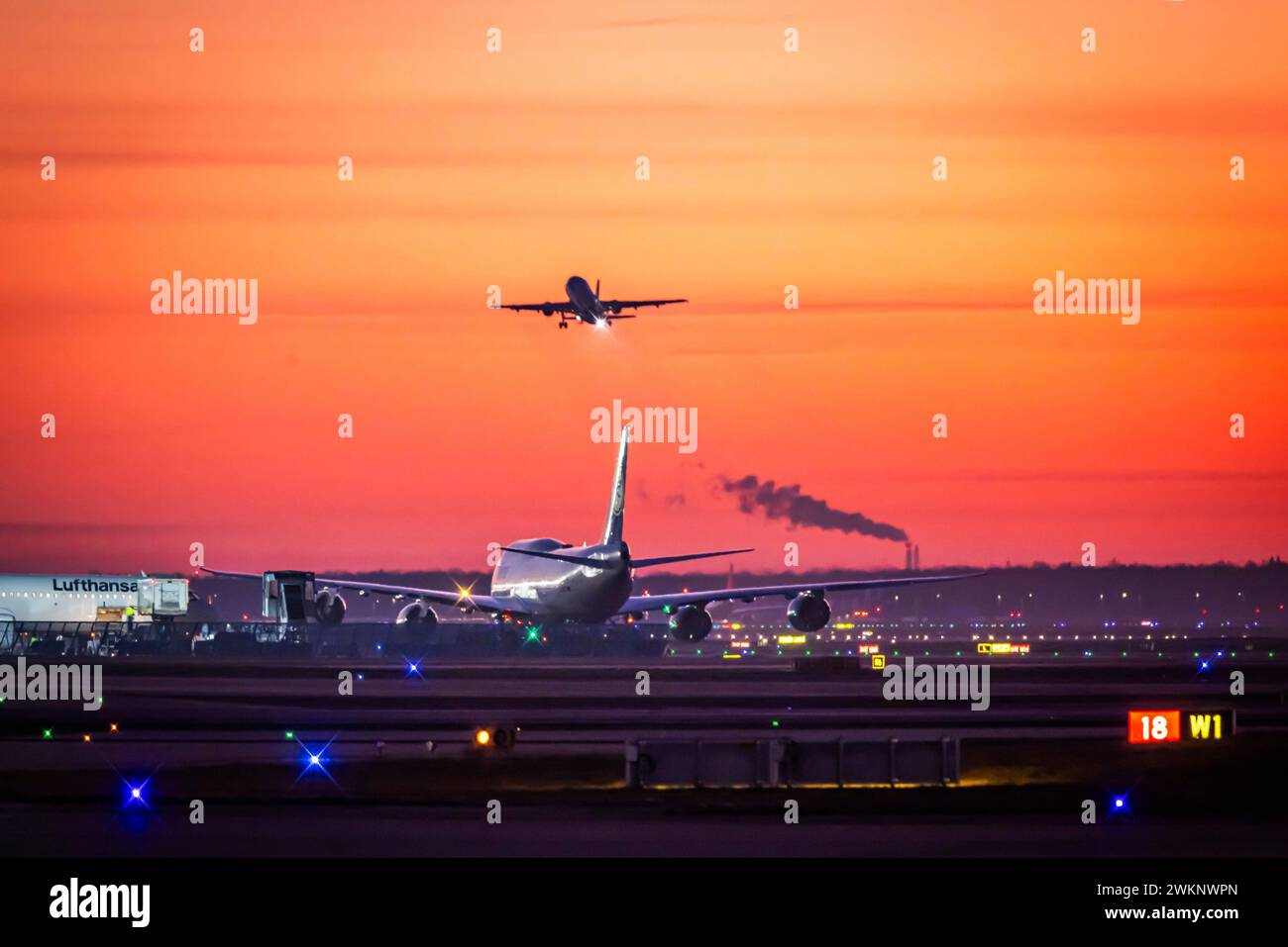 Early in the morning at the airport in front of sunrise, a Boeing 747 ...