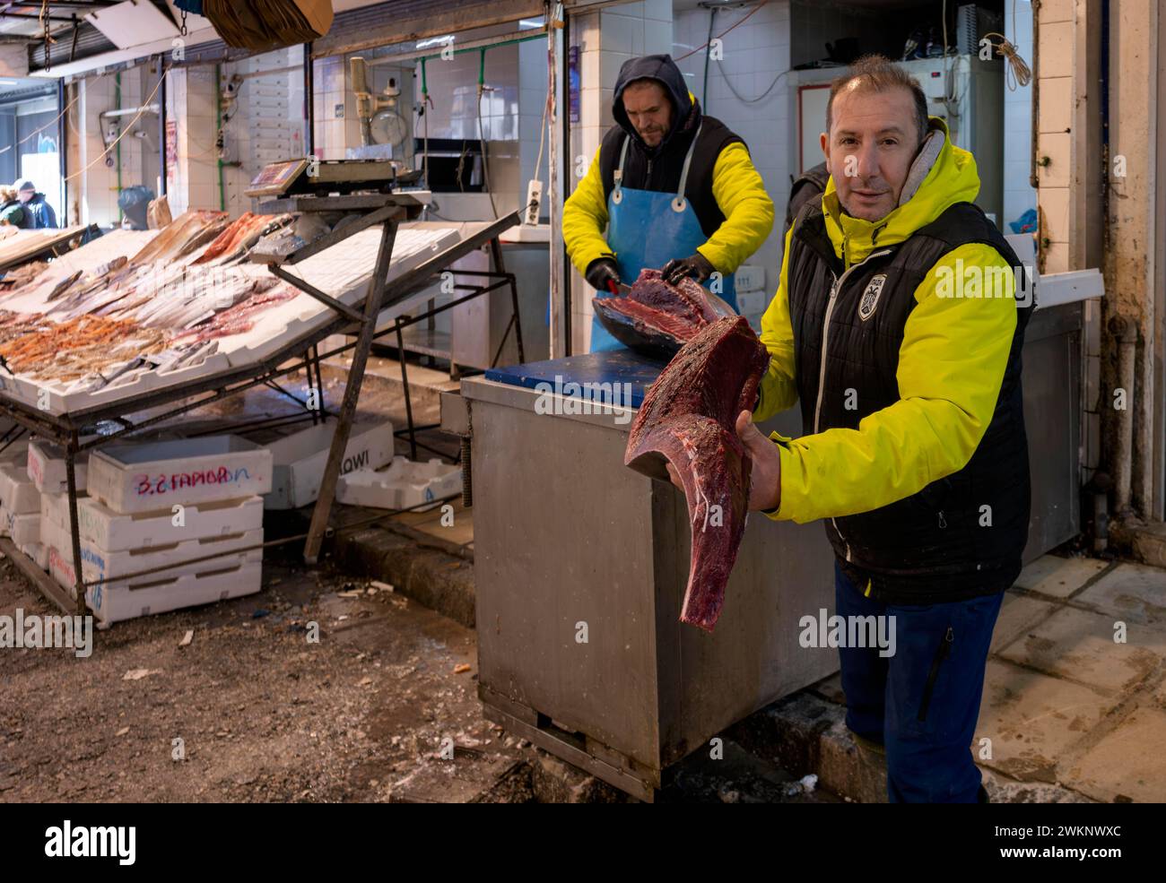 Trader, fishmonger posing proudly in front of his market stall, showing ...