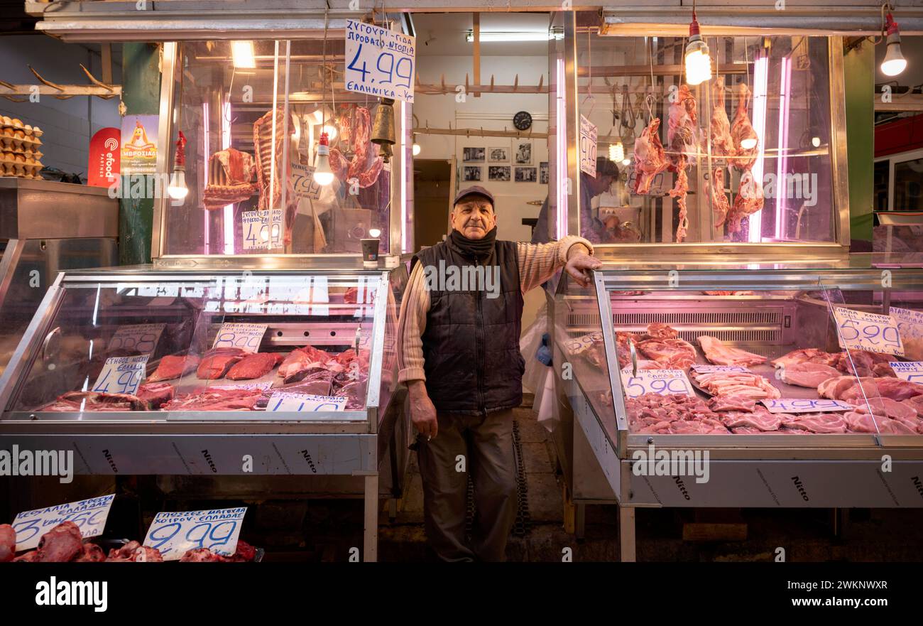 Butcher, meat trader posing proudly in front of his market stall ...