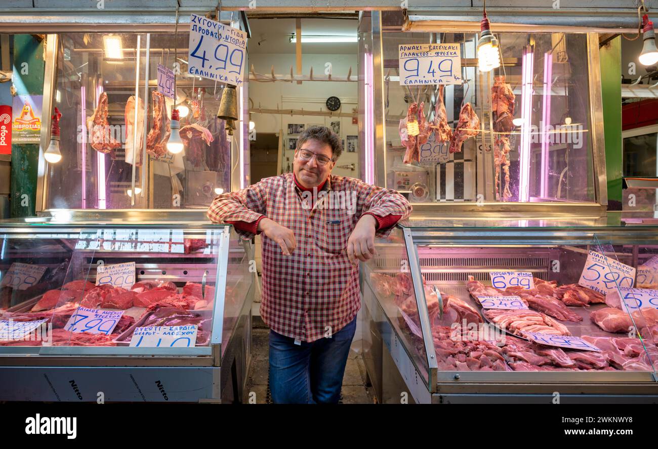 Butcher, meat trader posing proudly in front of his market stall ...