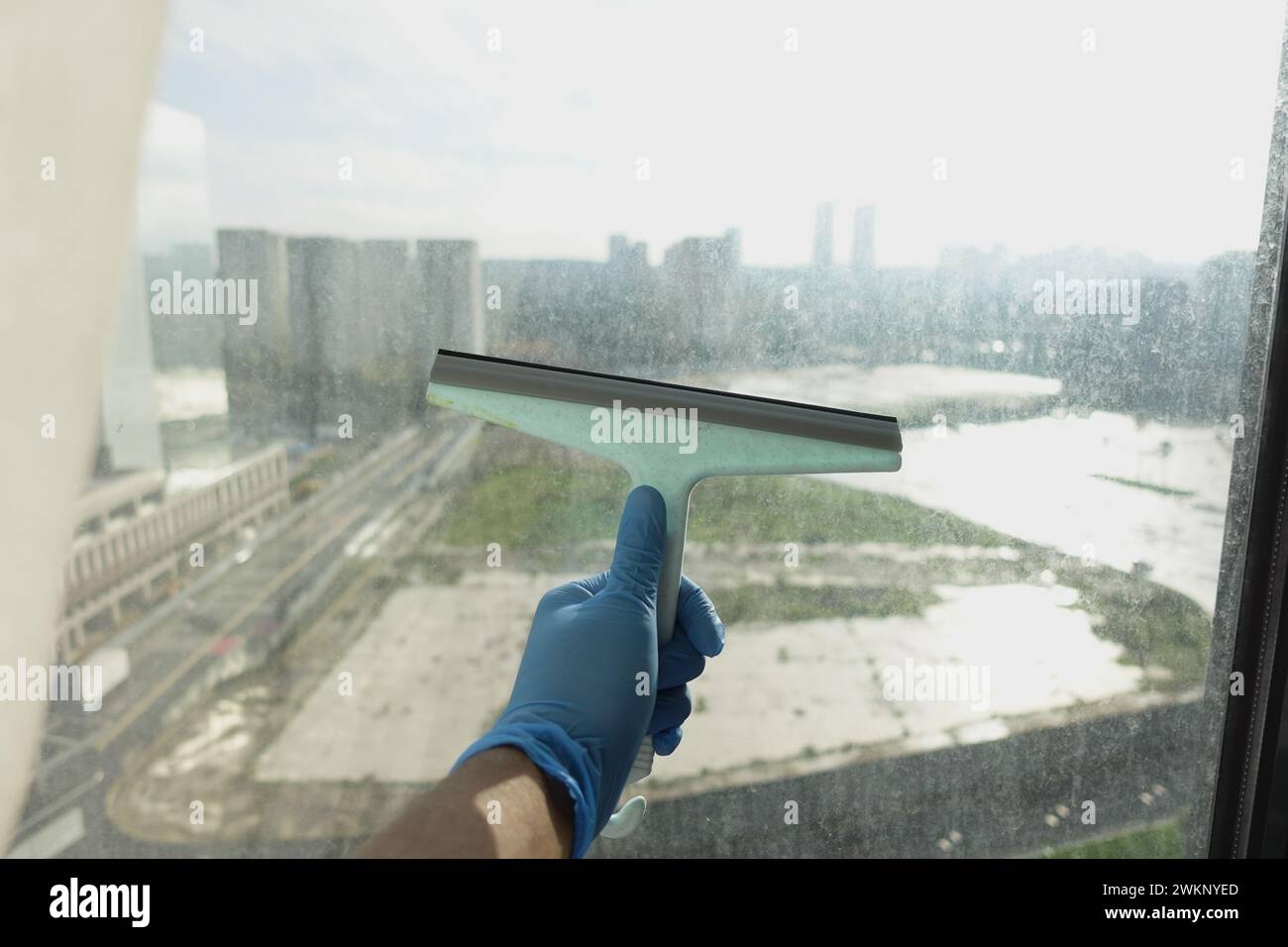 Rubber squeegee cleans a soaped window Stock Photo - Alamy