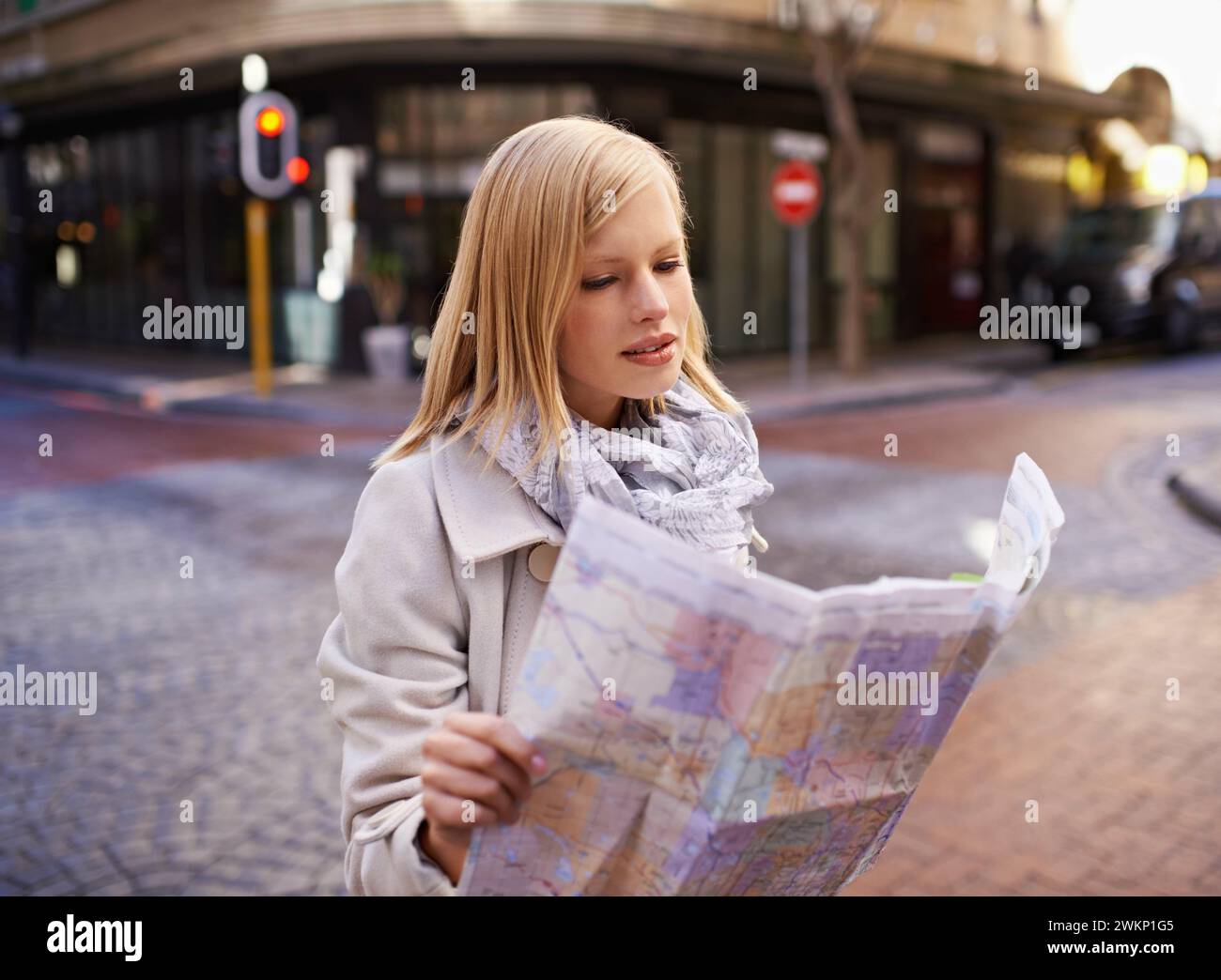 Woman, tourist and reading a map in city street for directions, travel ...