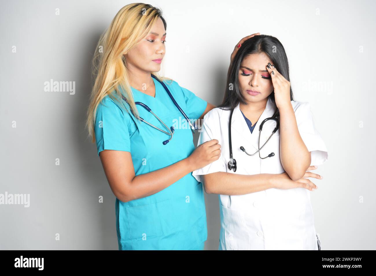 Female doctor using stethoscope to check patient's forehead Stock Photo ...
