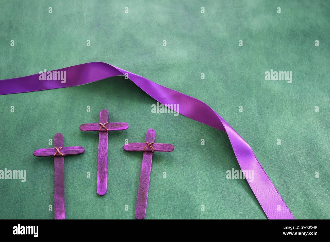 Three purple wooden cross in green background. Holy week and lent ...