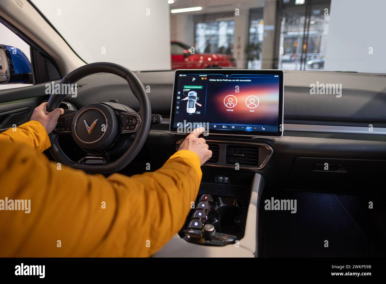 male hands uses display, gripping steering wheel Vinfast vf 8 electric ...