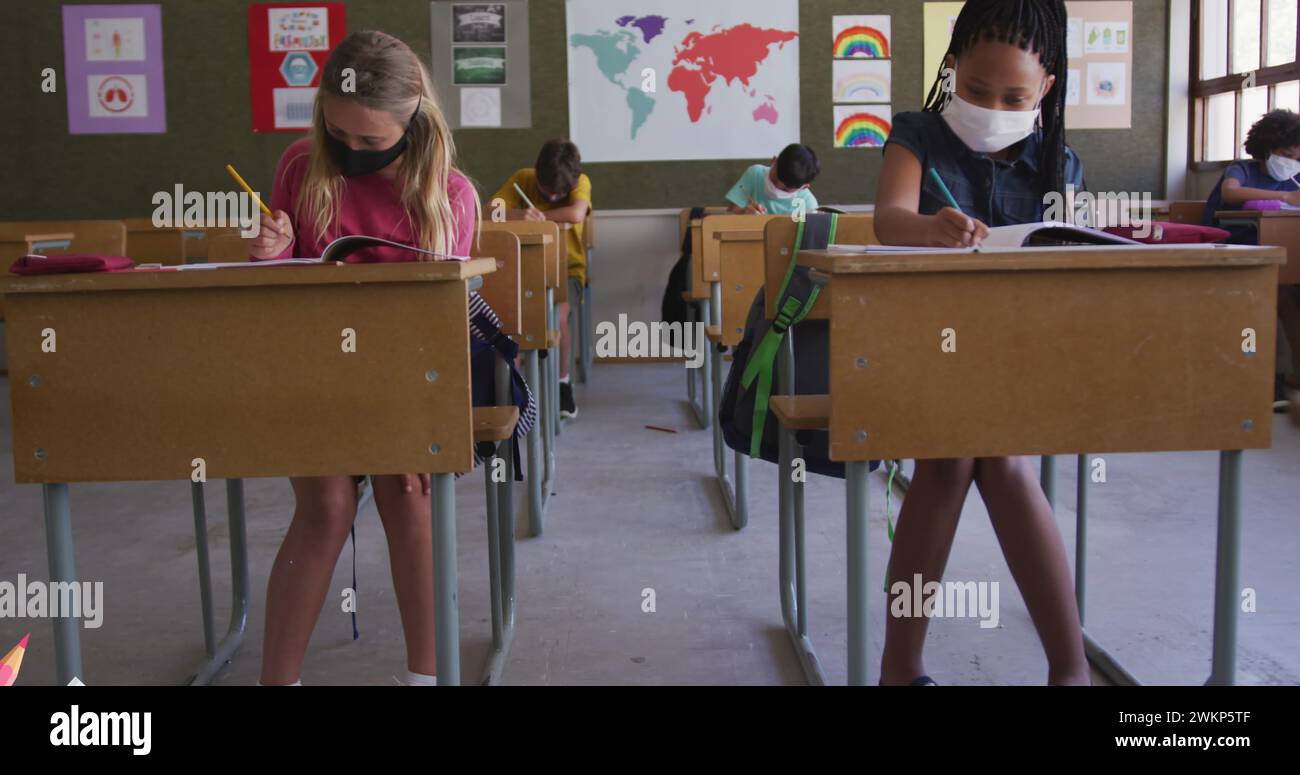 Image of school icons over kids sitting in the classroom touching each ...