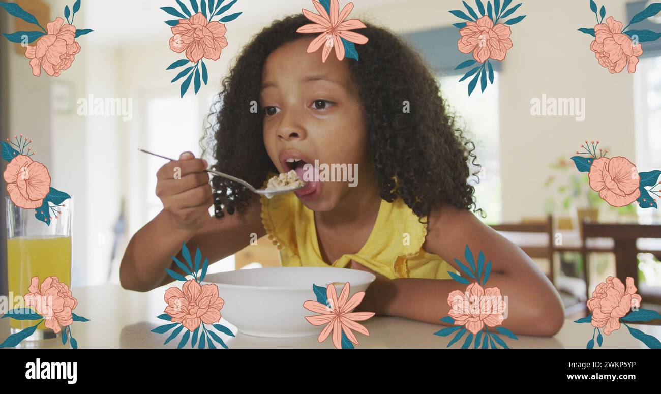 Image of flowers over african american girl eating breakfast at home Stock Photo - Alamy