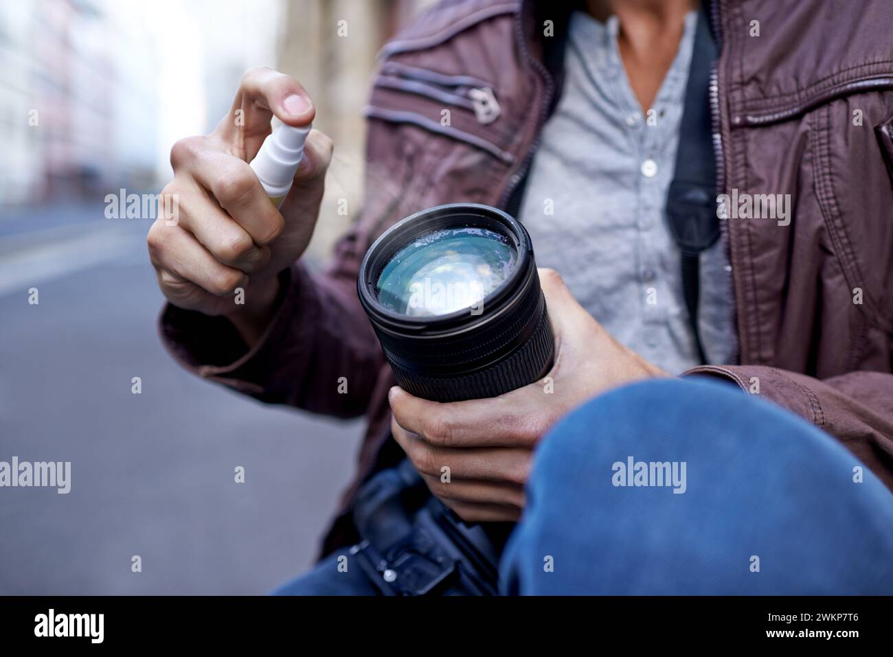 Hands, man and photographer with spray for camera lens to clean for ...