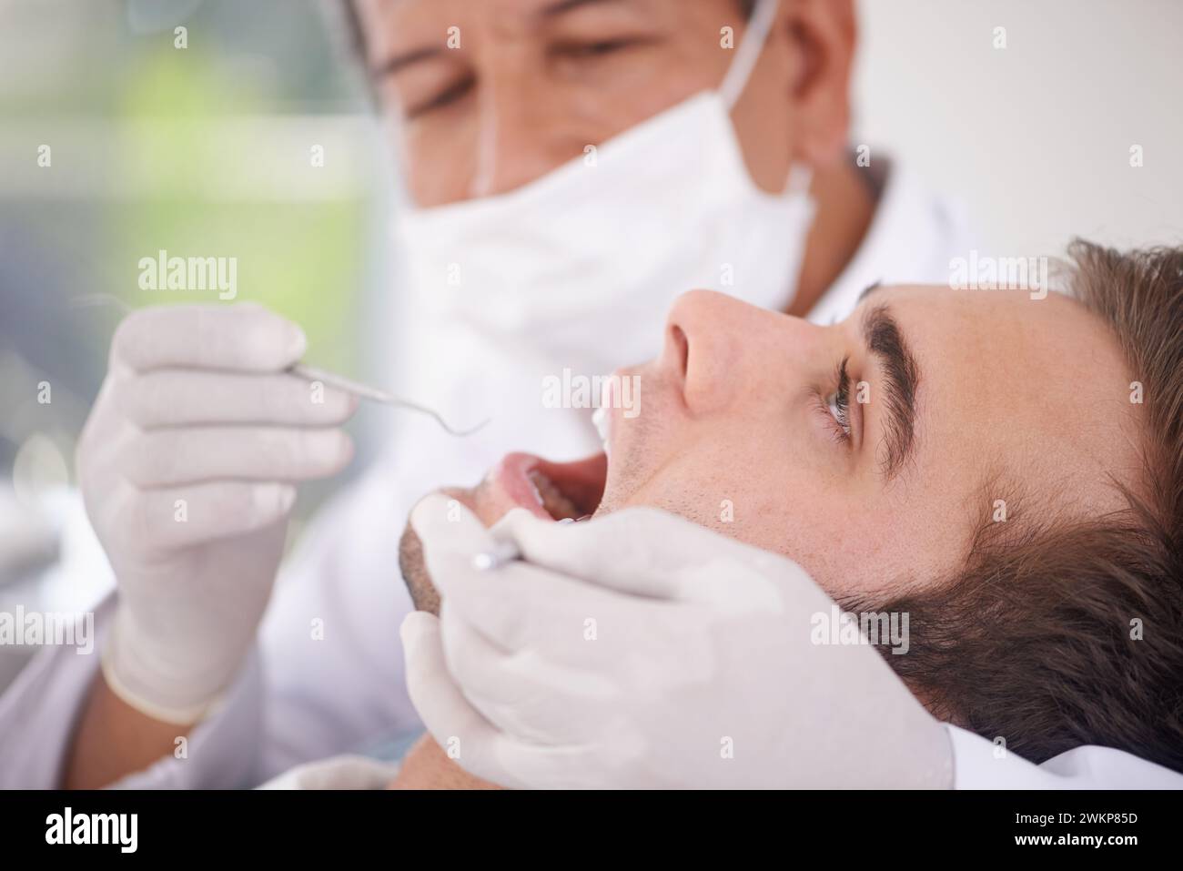 Dental, man and dentist with tools for healthcare, gum disease and oral ...