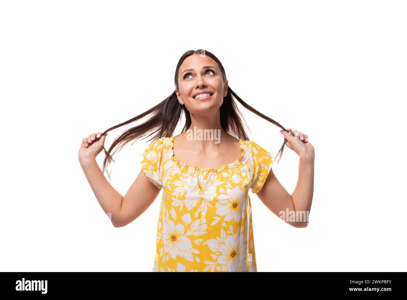 young pretty woman with straight black hair in a yellow sundress with a ...