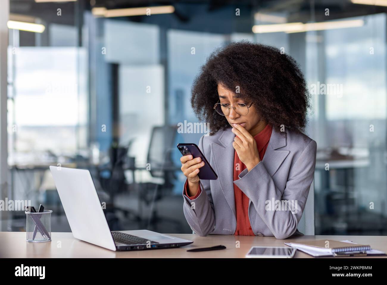 Sad woman with bushy hairstyle touching mouth with fingers with pitiful ...
