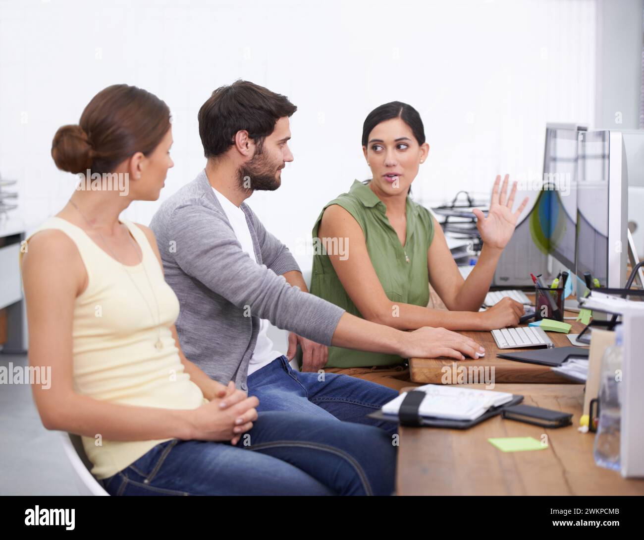 Meeting, coworking space and man with women at desk for conversation ...