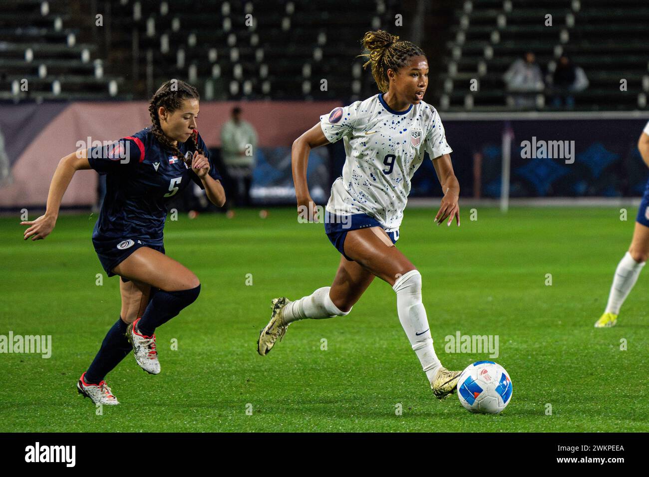 United States forward Midge Purce (9) is defended by Dominican Republic ...