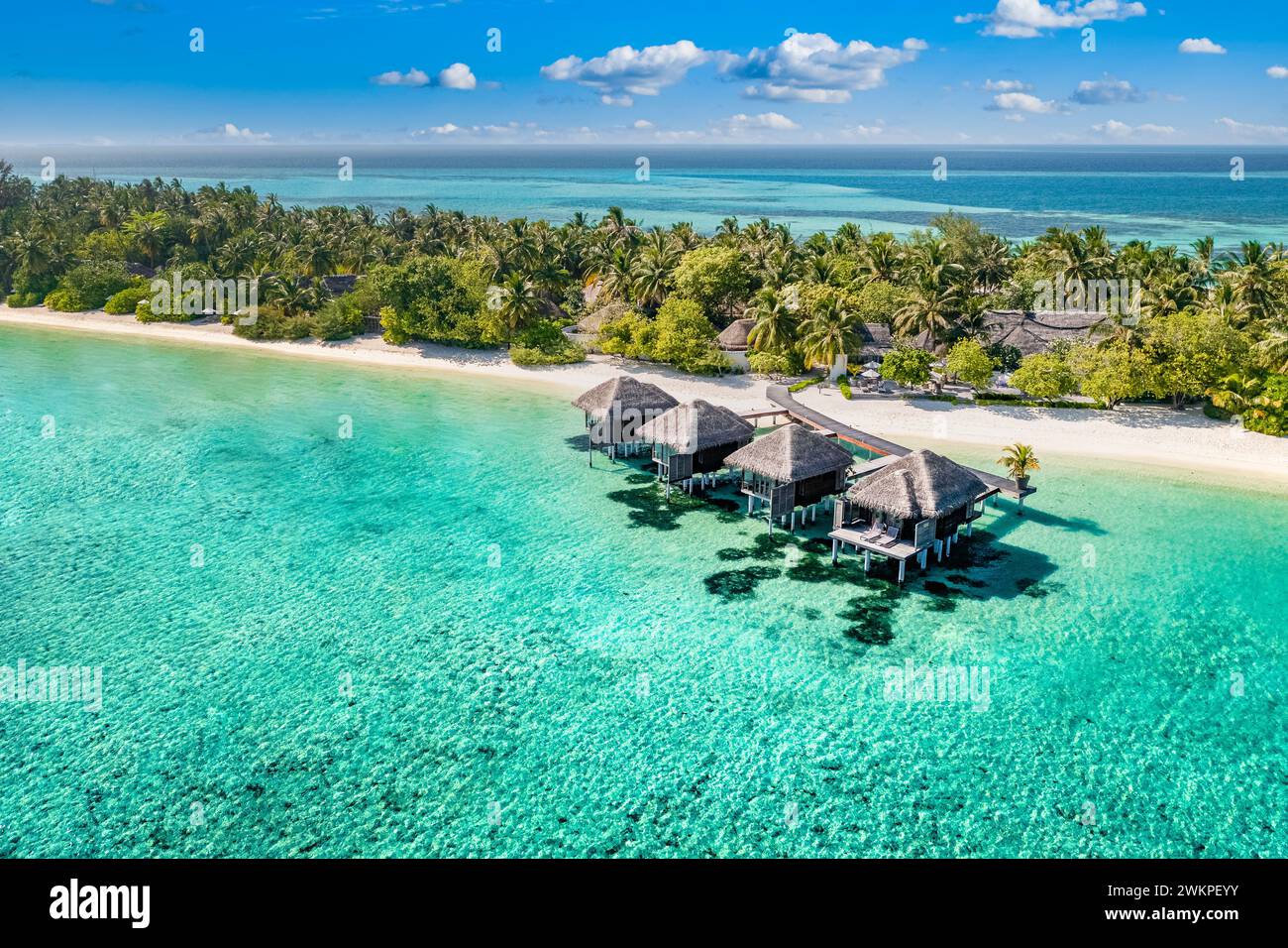 Perfect aerial landscape, luxury tropical resort with water villas. Beautiful island beach, palm ...