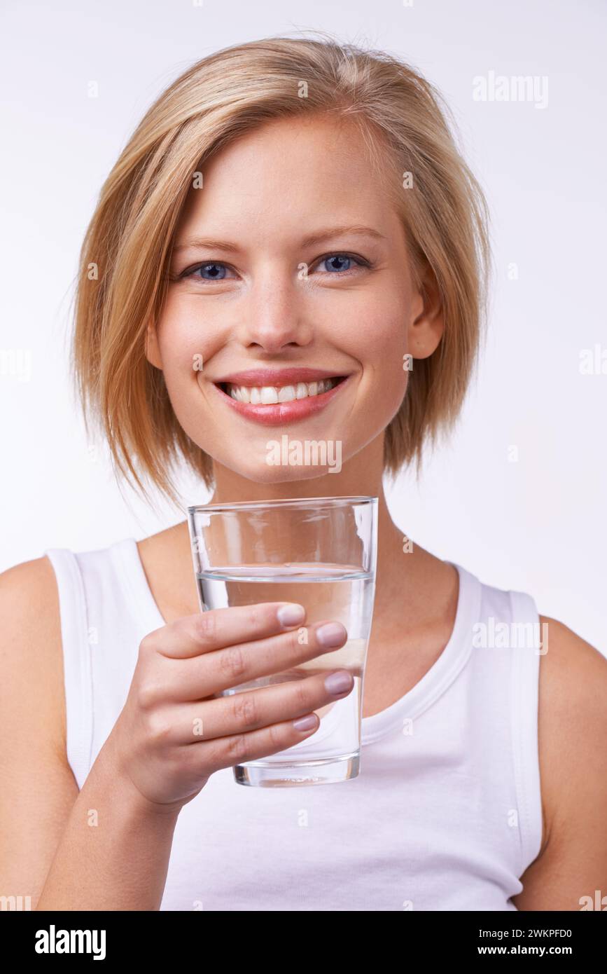 Drinking water, portrait and happy woman for wellness, nutrition and ...