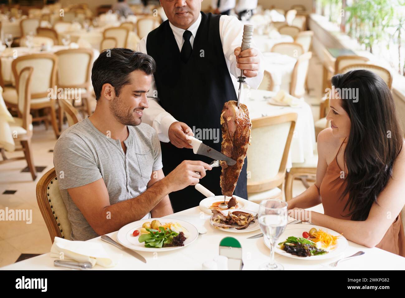 Happy couple, date and dining with kebab of waiter serving, meat or ...