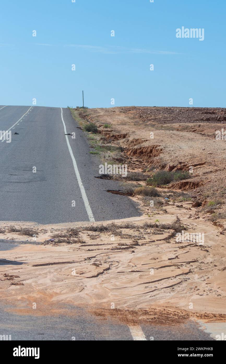 Road damaged by ex tropical cyclone Kirrily in the Australian Outback ...